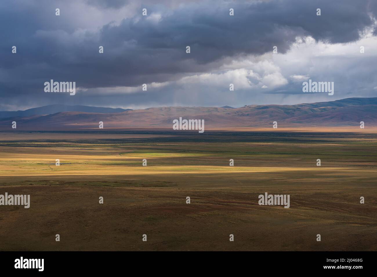 Amazing evening landscape with streaks of sunlight in the steppe at ...