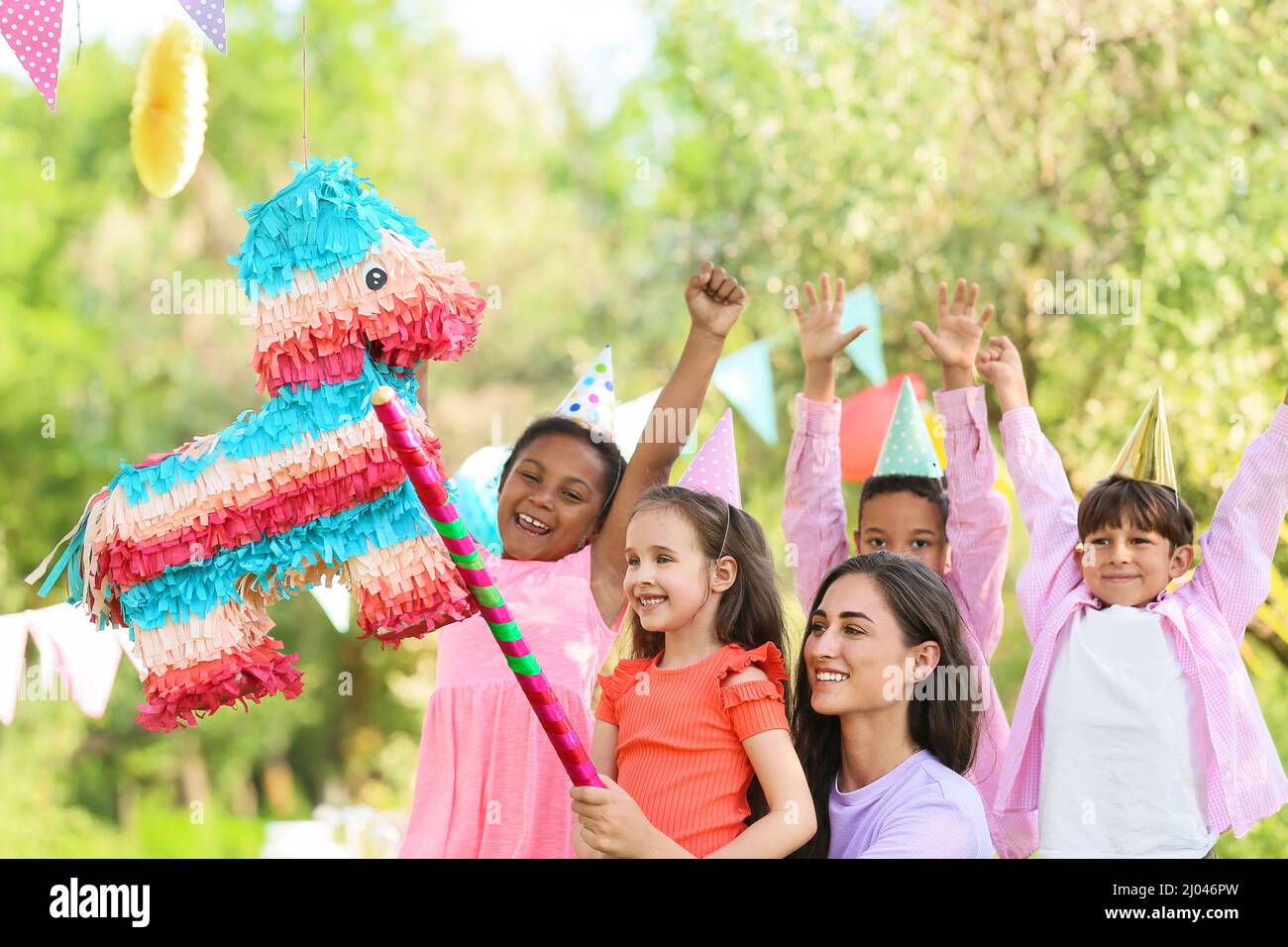 Woman and cute children at pinata birthday party Stock Photo - Alamy