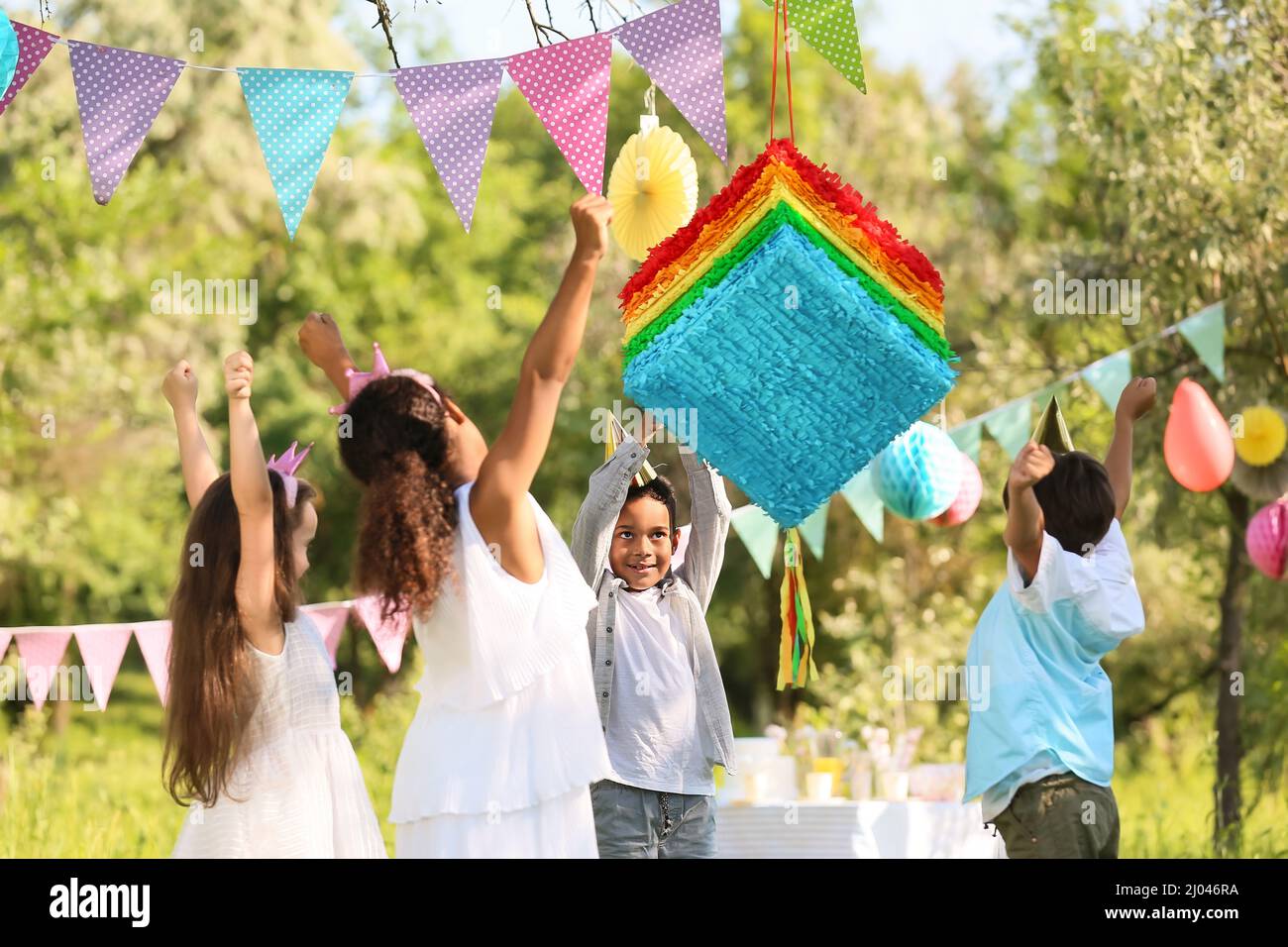 Cute children at pinata birthday party Stock Photo - Alamy