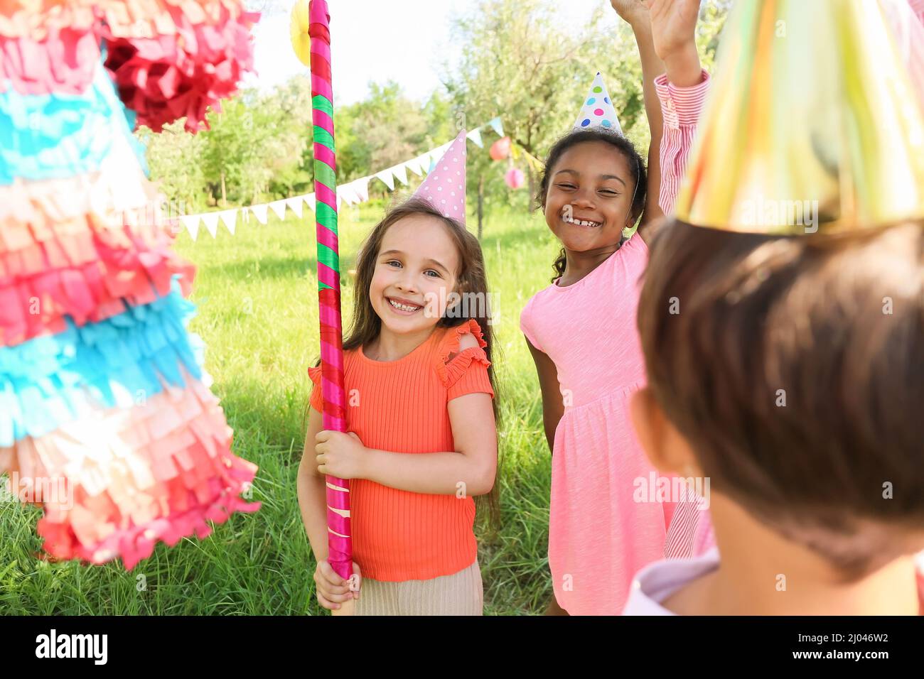 Cute children at pinata birthday party Stock Photo - Alamy