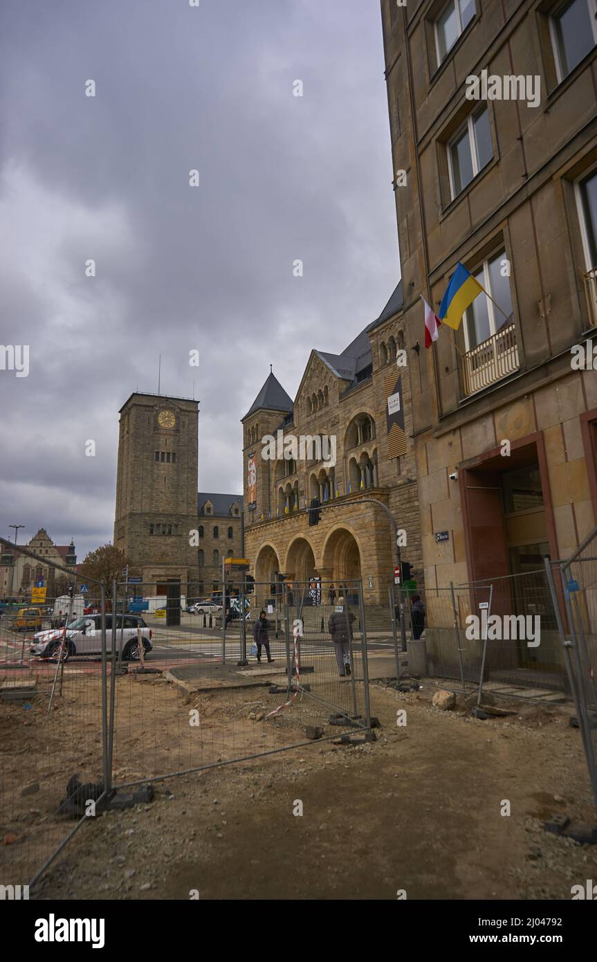 Footpath and metal barriers next to a building with the Ukrainian flag ...
