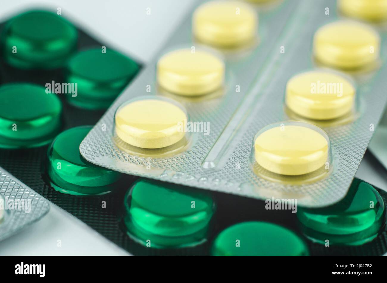 Packs of pills close-up. Yellow and green pills in blister packs Stock ...