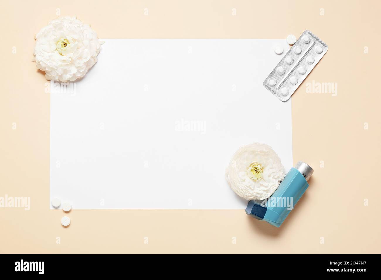 Composition with blank sheet of paper, inhaler, pills and flowers on ...