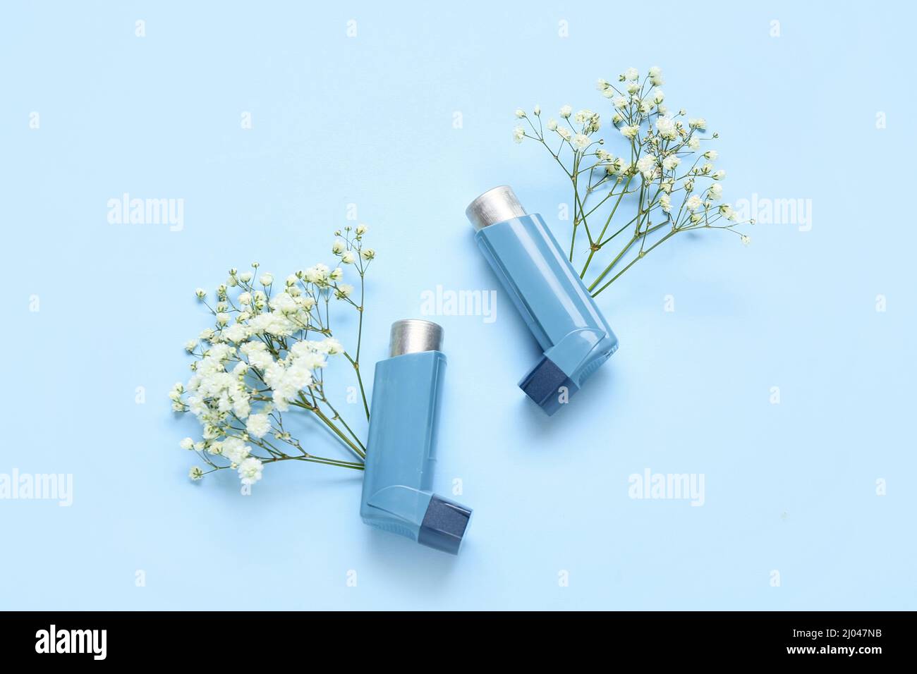 Composition with inhalers and gypsophila flowers on color background ...