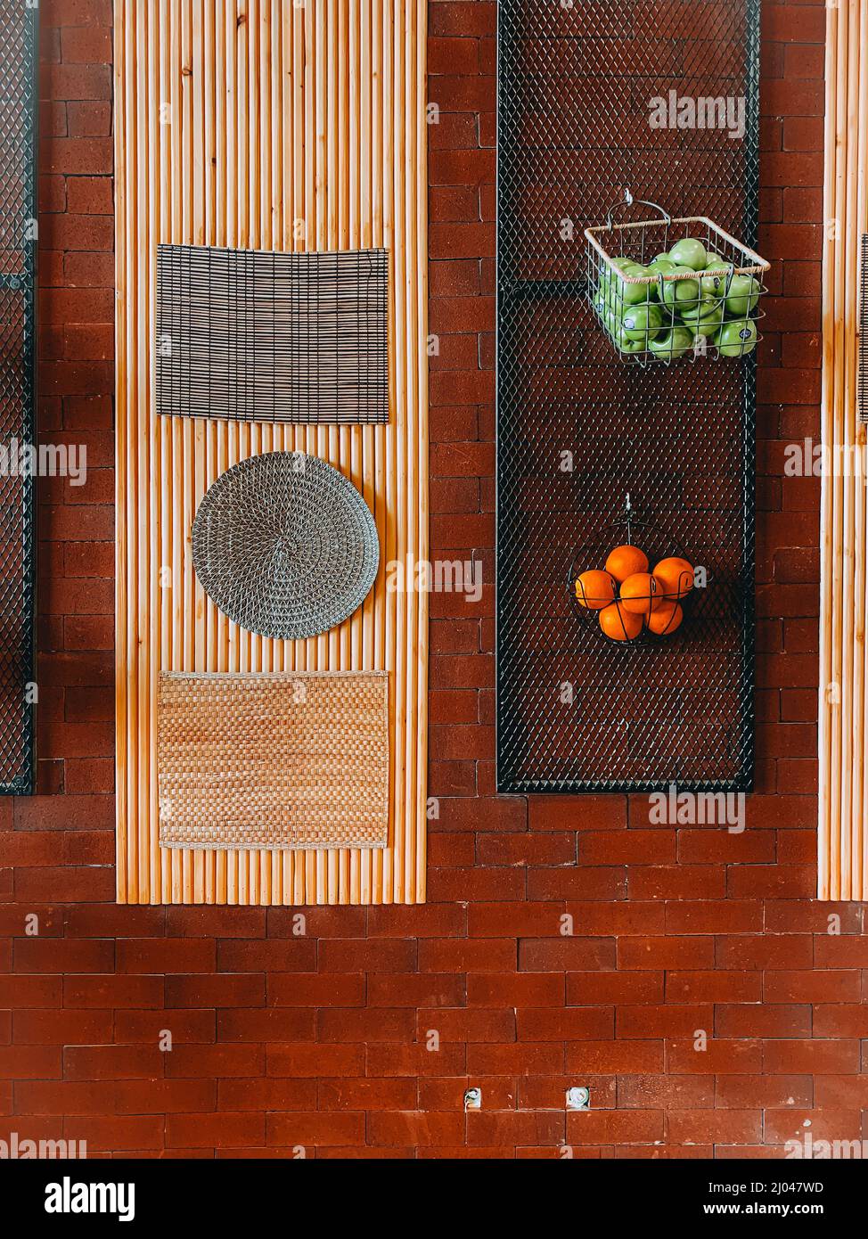 Vertical shot of fruits and decorations hanging on a brick wall Stock ...