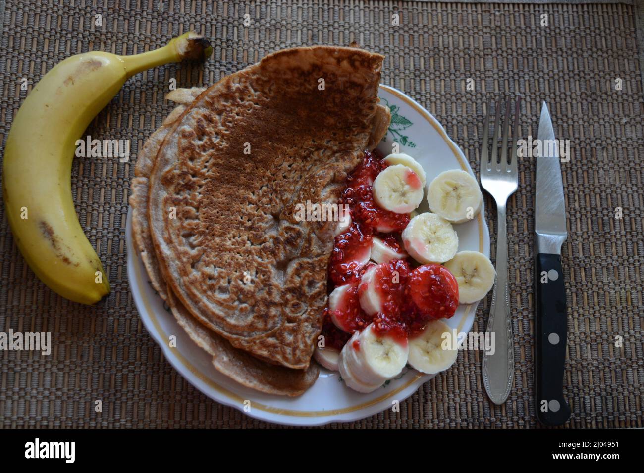 Fresh sliced bananas with sweet raspberry jam and chocolate pancakes ...