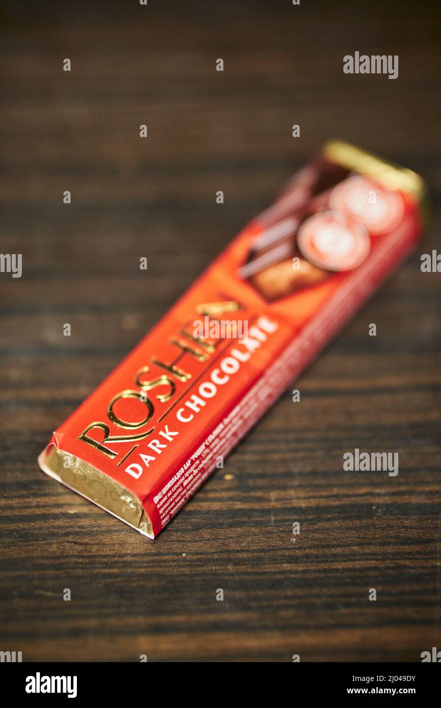 Close-up shot of Roshen brand Dark Chocolate candy bar on a wooden ...