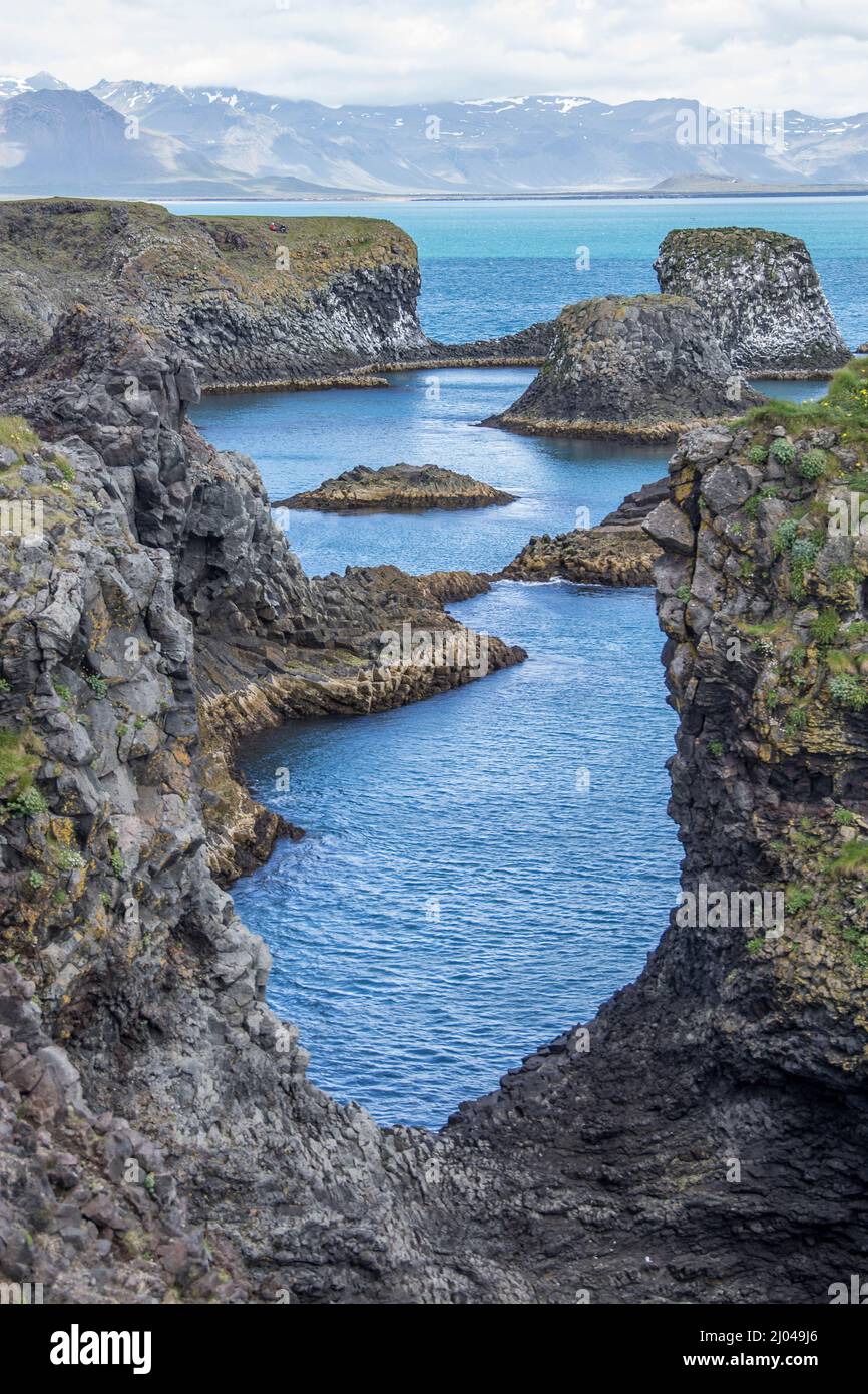 Cliffs of Arnastapi, Iceland, an eroded steep coast with caves, rock ...
