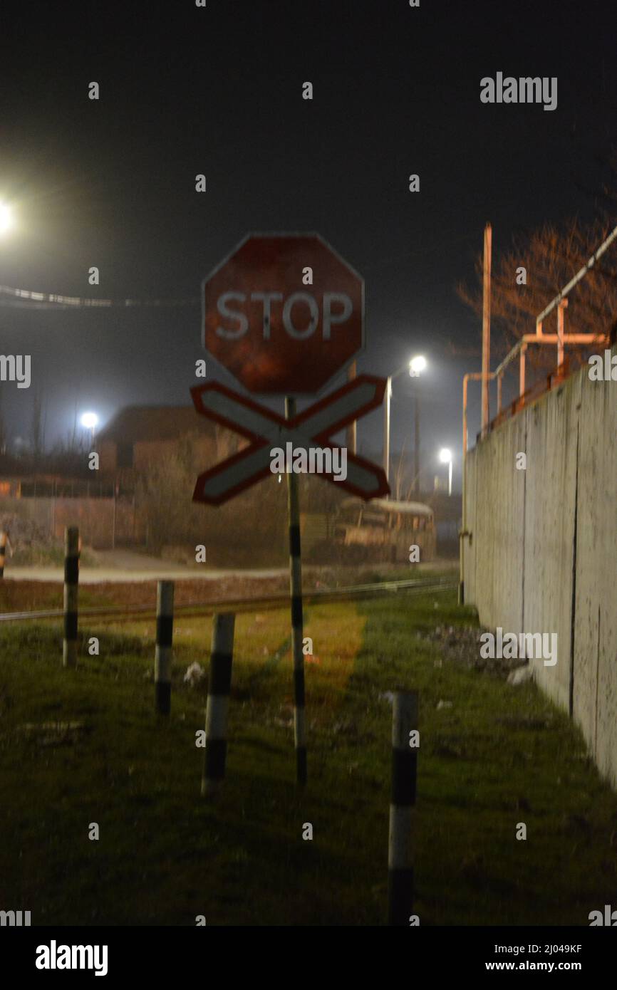 Road signs, a large metal, round stop sign at the junction of roads in ...