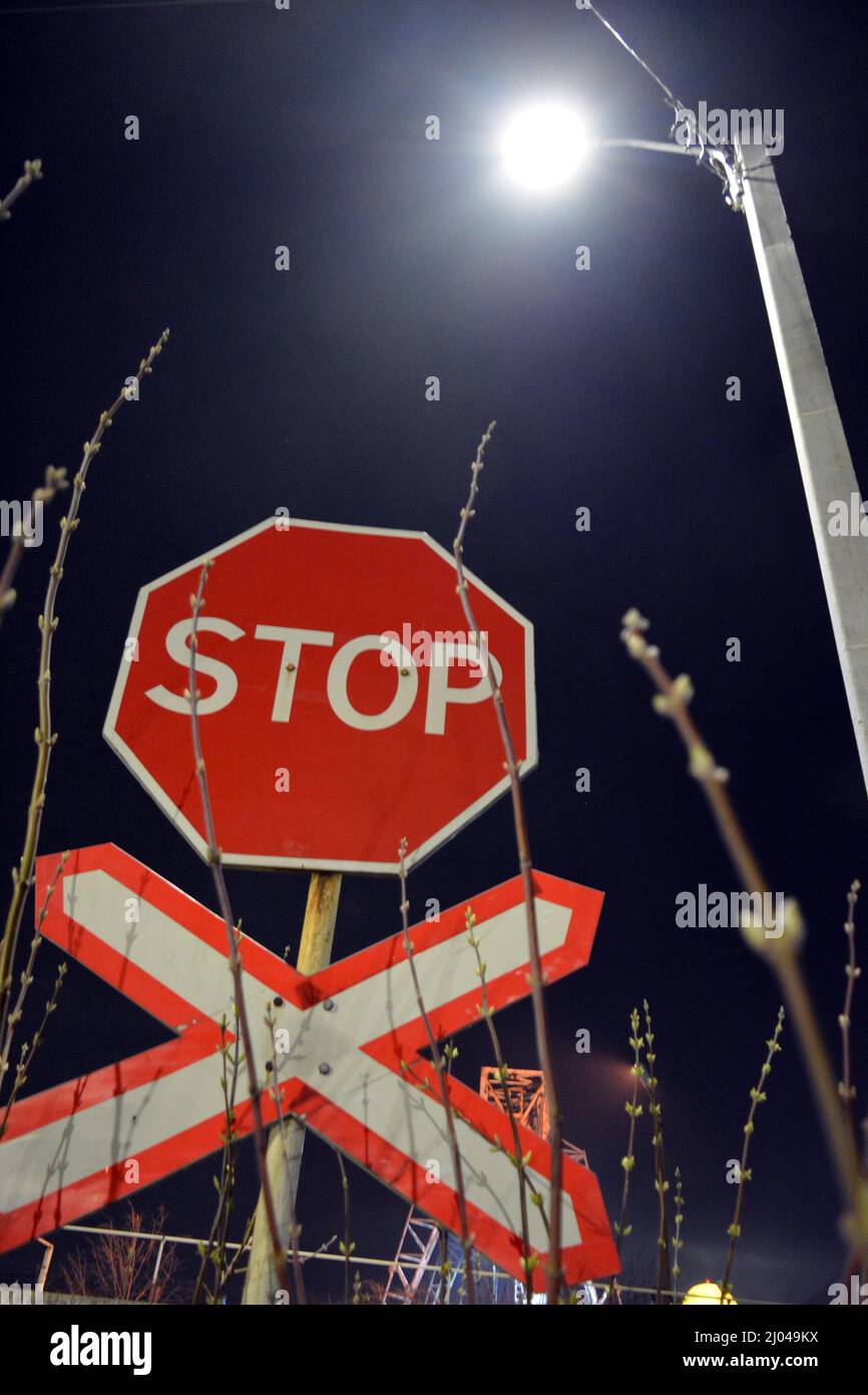 Road signs, a large metal, round stop sign at the junction of roads in ...