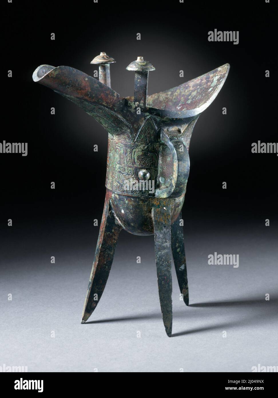 Small Ritual Wine Warmer (Jue) with Masks. China, Late Shang dynasty ...