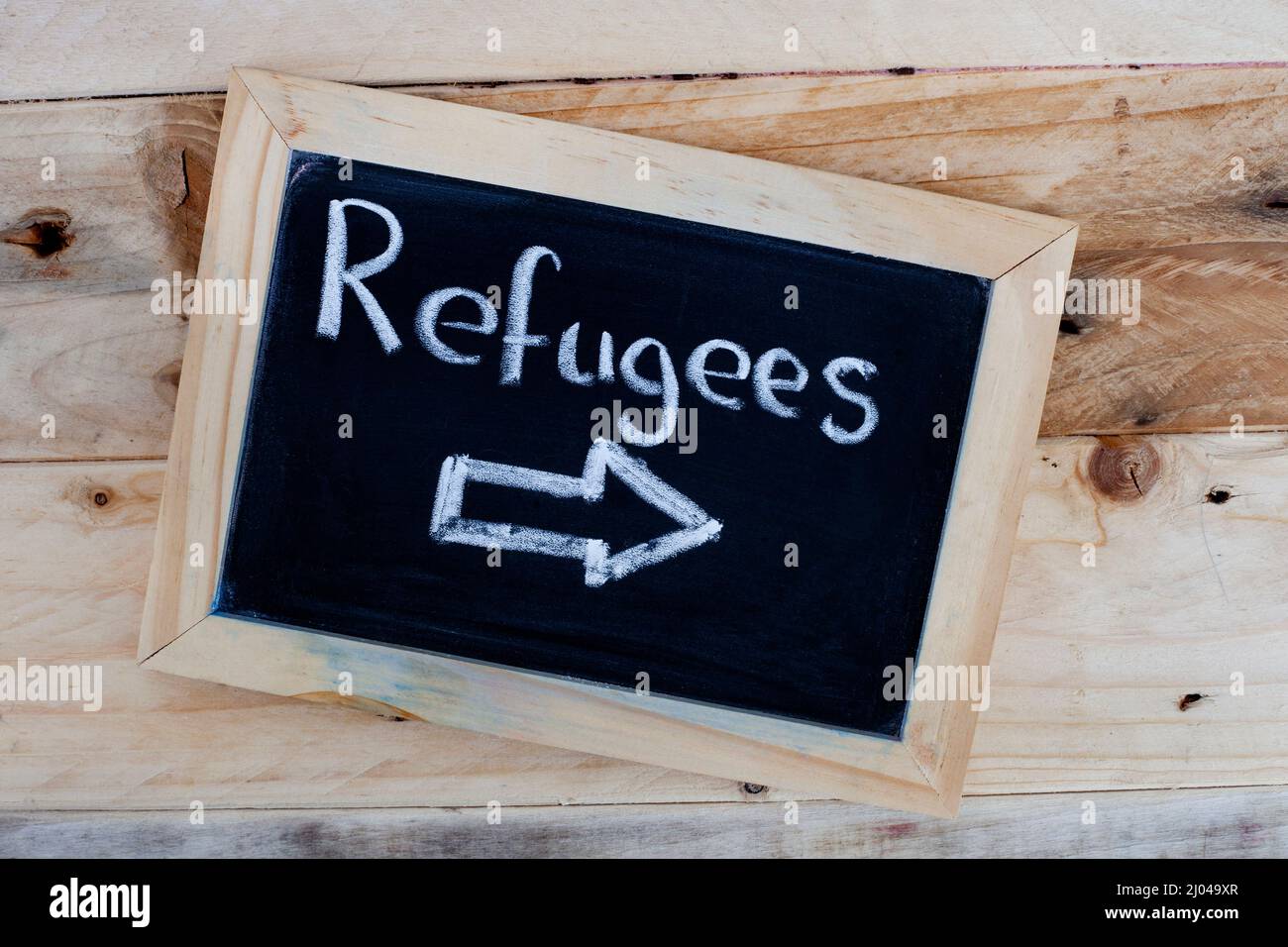 Chalkboard sign showing direction for refugees Stock Photo - Alamy
