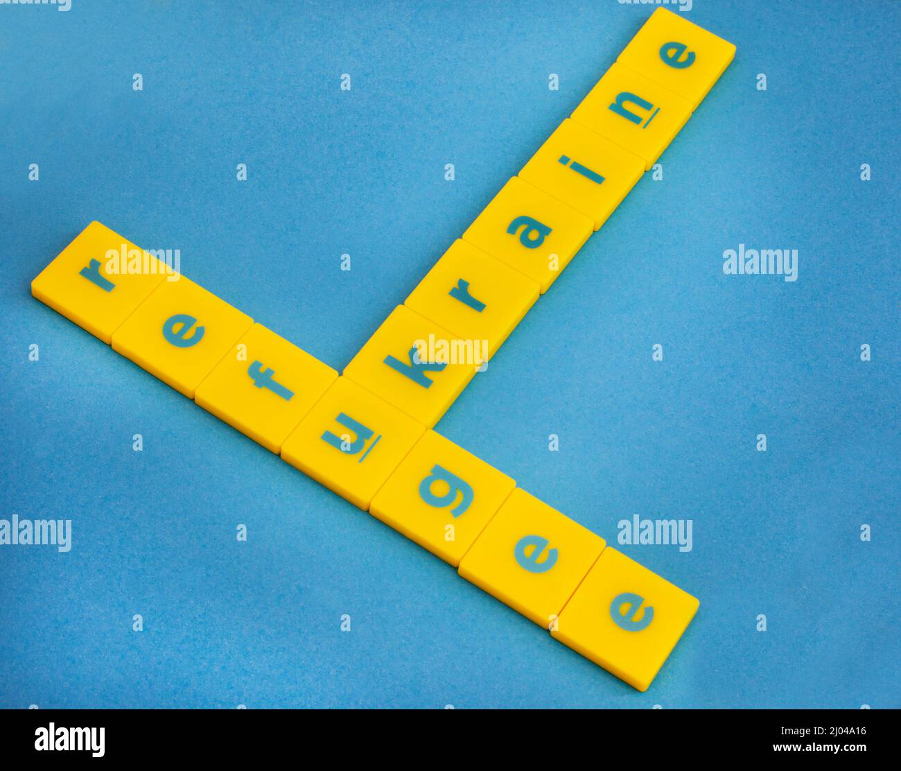 Yellow and blue scrabble tiles spelling Ukraine and refugee Stock Photo ...