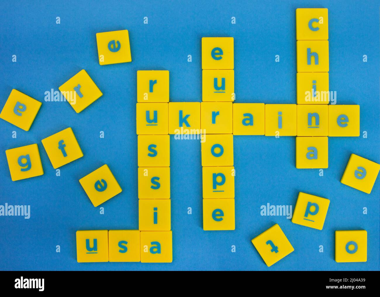 Yellow and blue scrabble tiles spelling Ukraine, Russia, Europe, USA ...