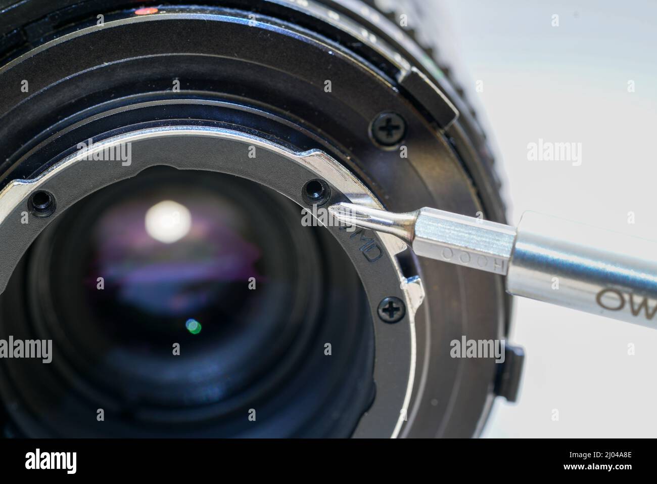 Clean and disassemble the lens for photography into its component parts ...