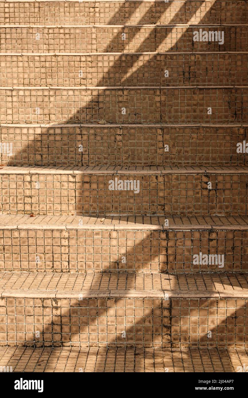 Vertical shot of an outdoor brick staircase with railing shadow Stock ...