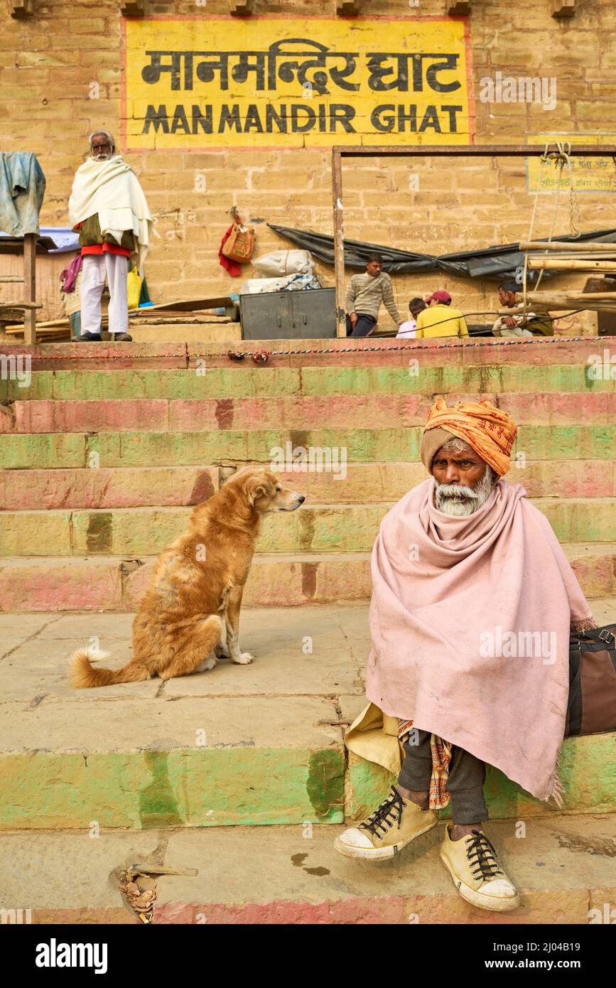 India. Varanasi Benares Uttar Pradesh. Old man and dog on the ghat of ...