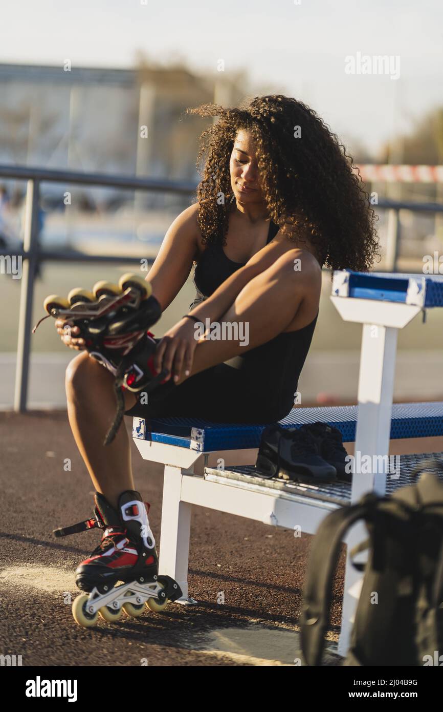 Vertical shot of a beautiful girl wearing her shoes Stock Photo - Alamy