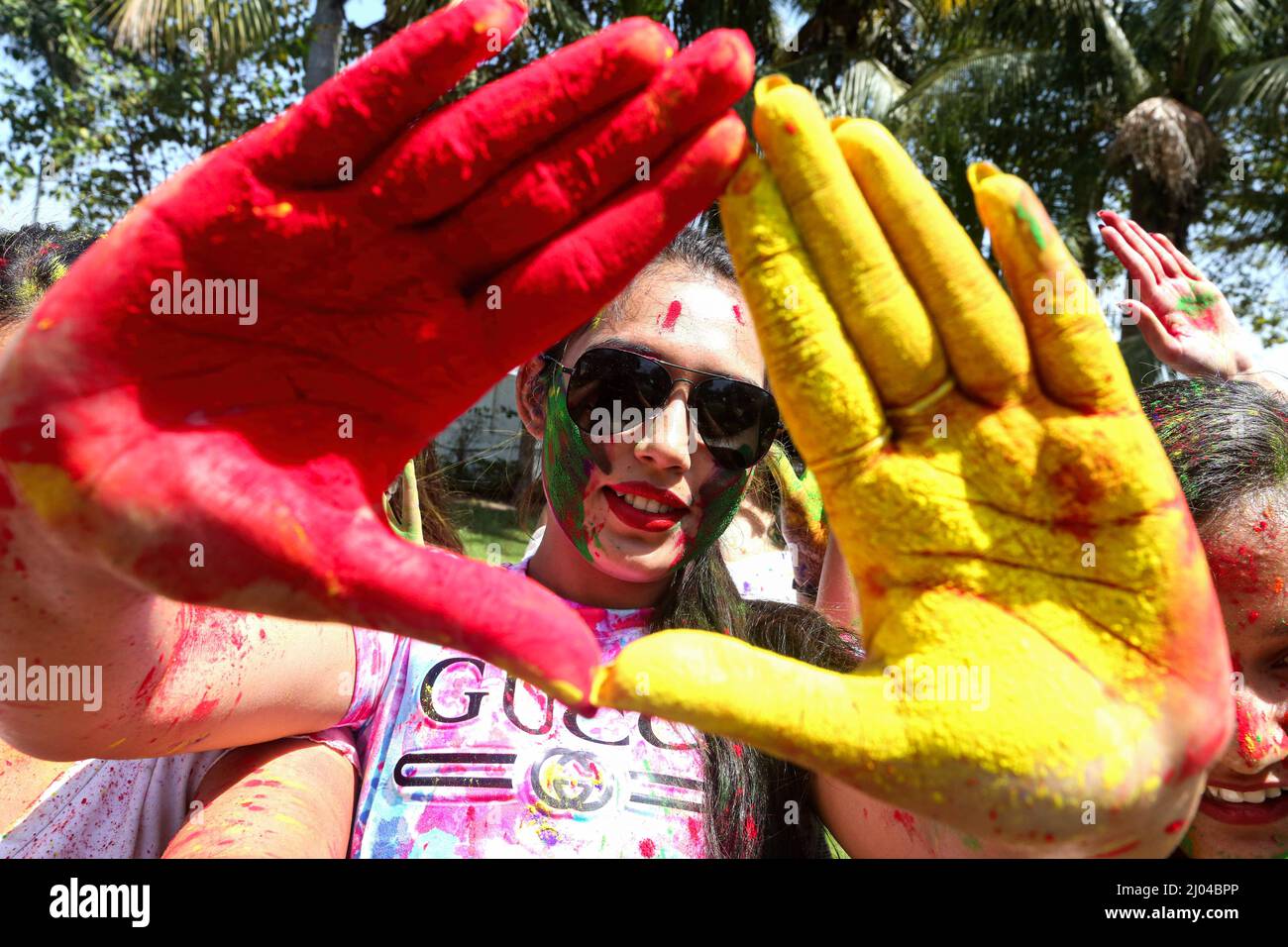 An Indian young woman shows her colorful fingers ahead of the Holi ...