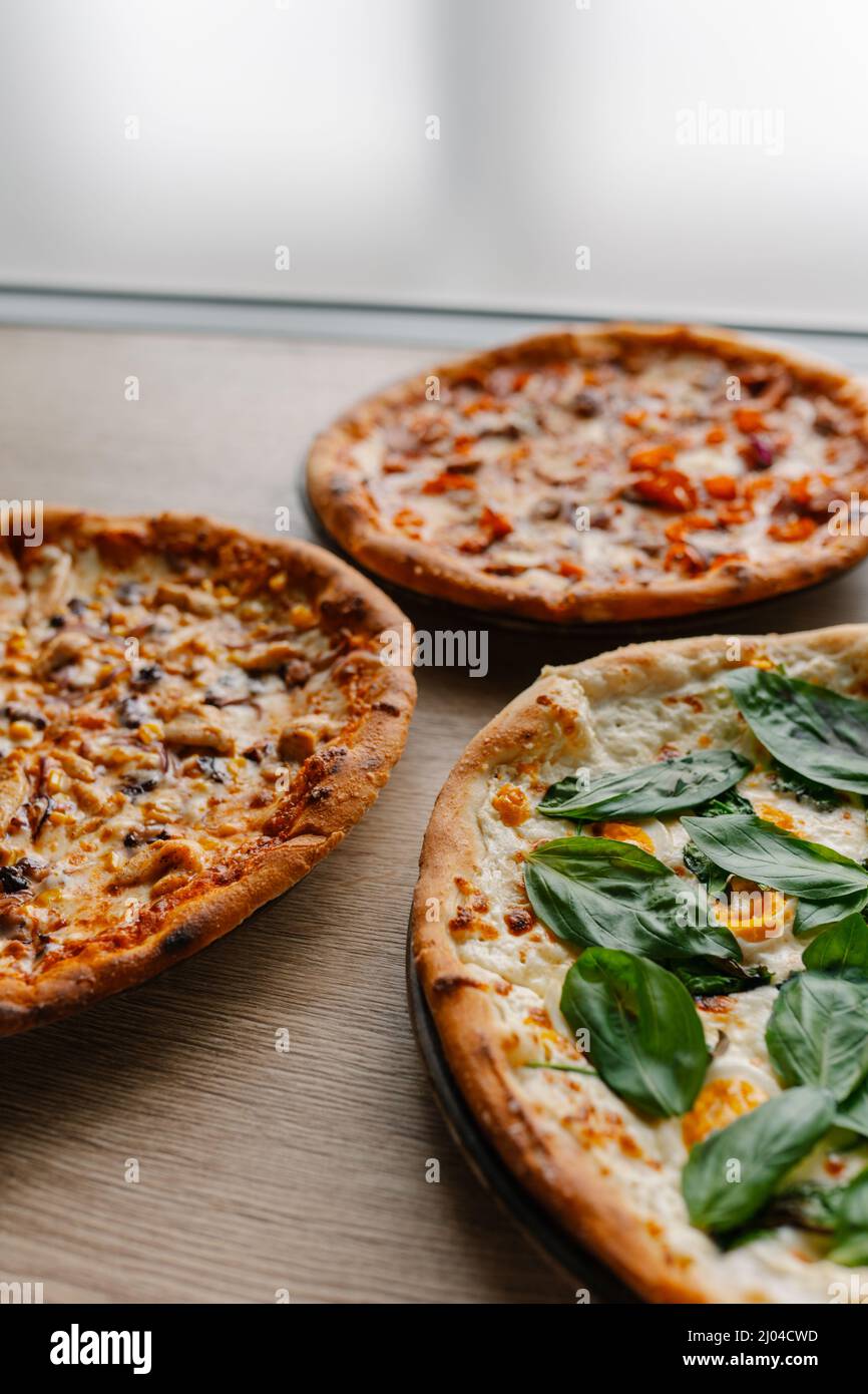 Photo of multiple pizzas on table Stock Photo - Alamy