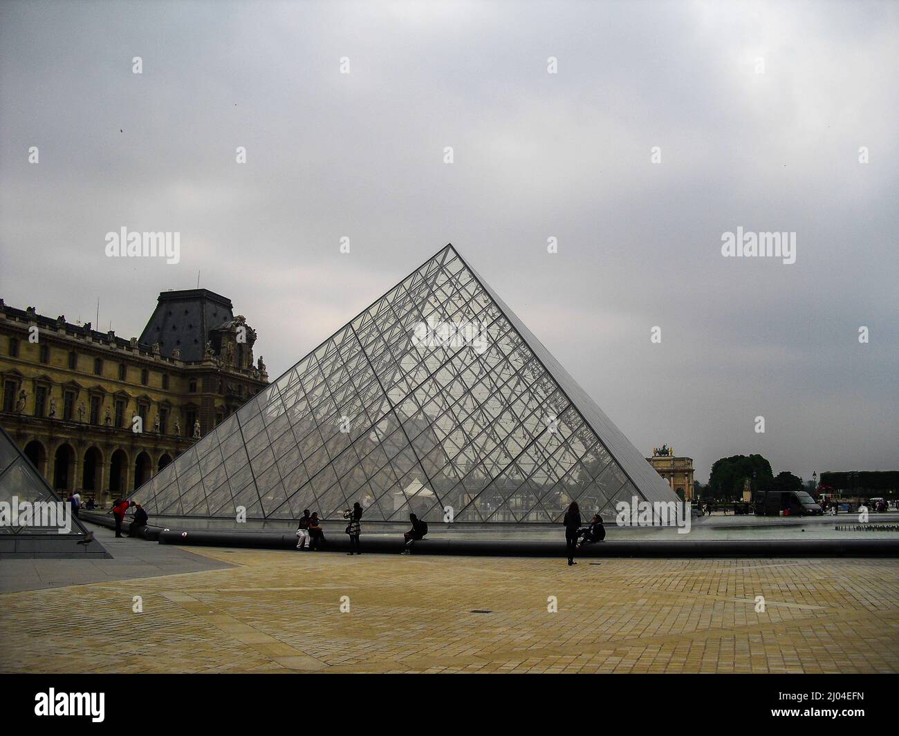 Louvre Glass Pyramid on a gloomy day in Paris, France Stock Photo - Alamy