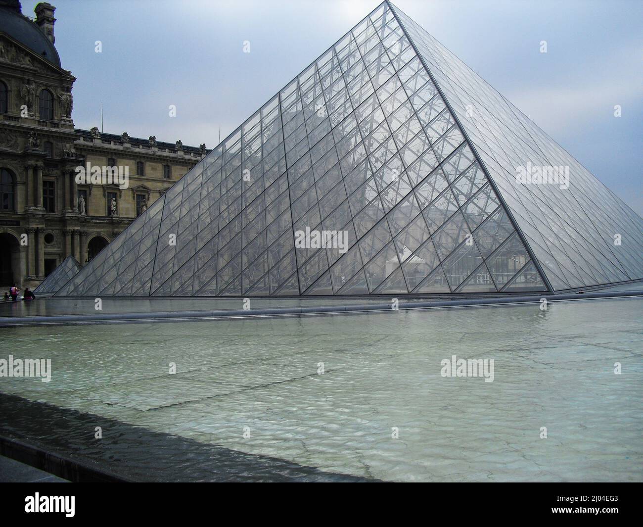 Louvre Glass Pyramid on a gloomy day in Paris, France Stock Photo - Alamy