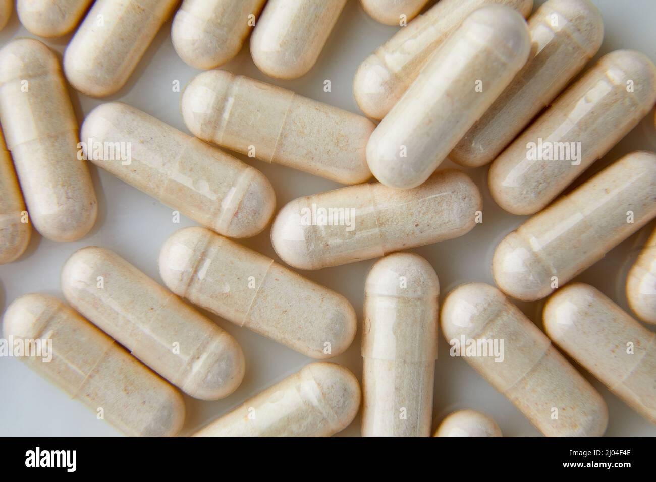 Flat lay macro White beige capsule pills, tablets, top view, close up ...