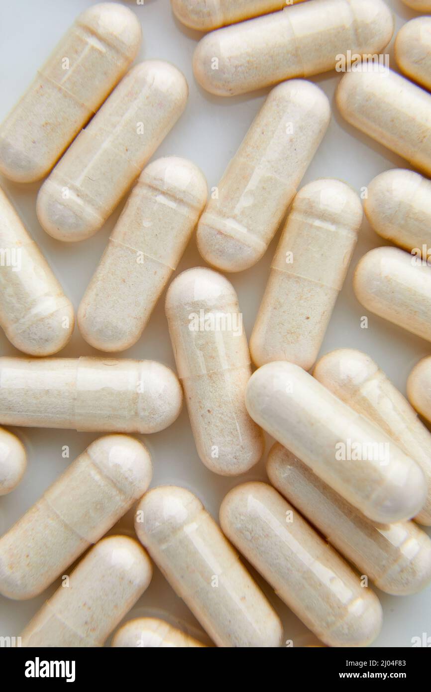 Flat lay macro White beige capsule pills, tablets, top view, close up ...