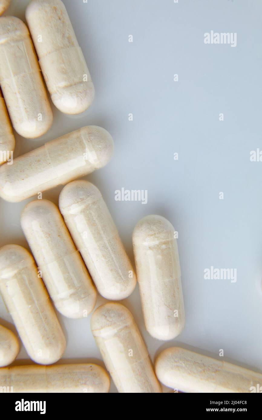 Flat lay macro White beige capsule pills, tablets, top view, close up ...