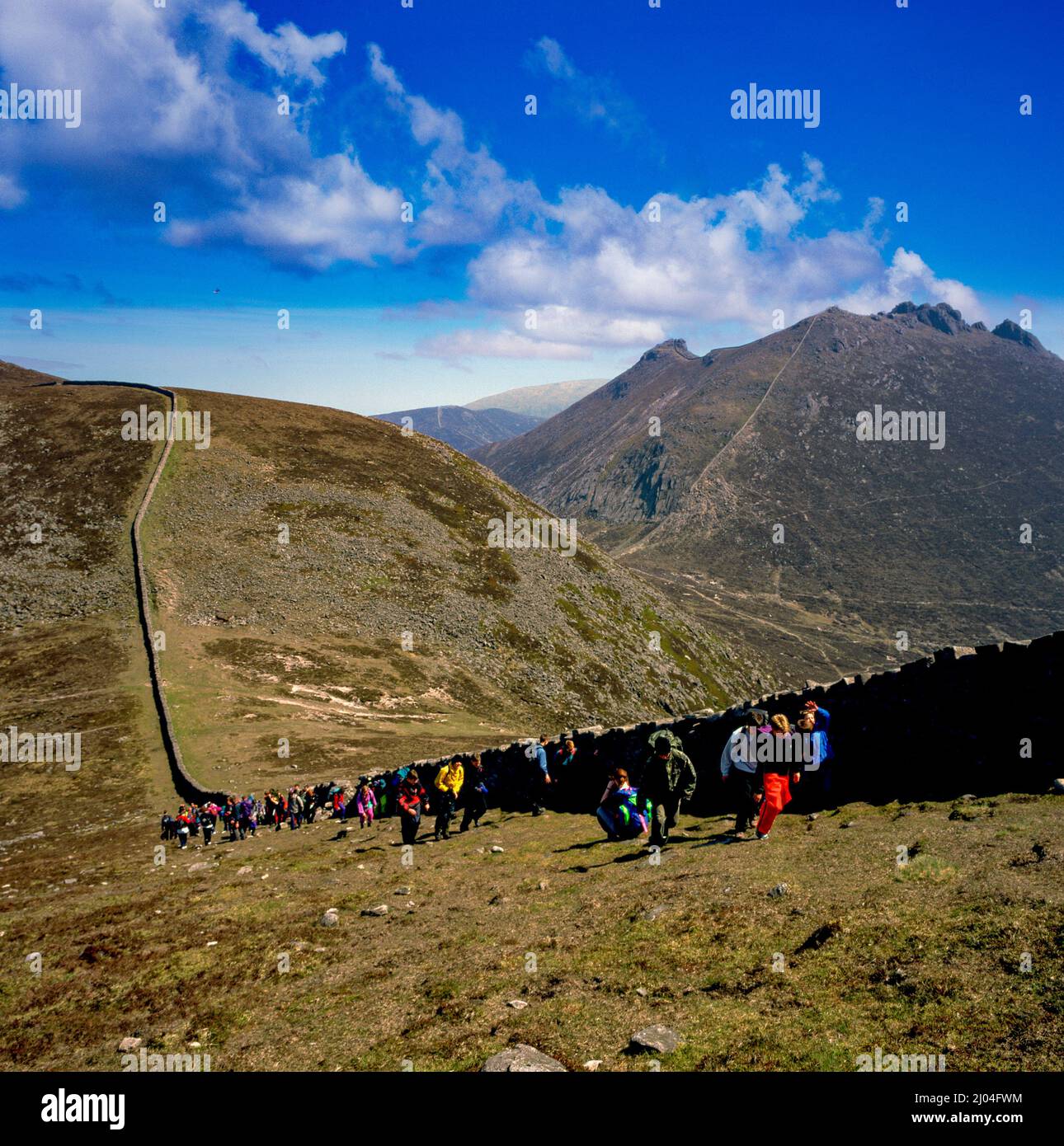 Walkers at the Mourne wall with Slieve Bearnagh in the nbackground ...