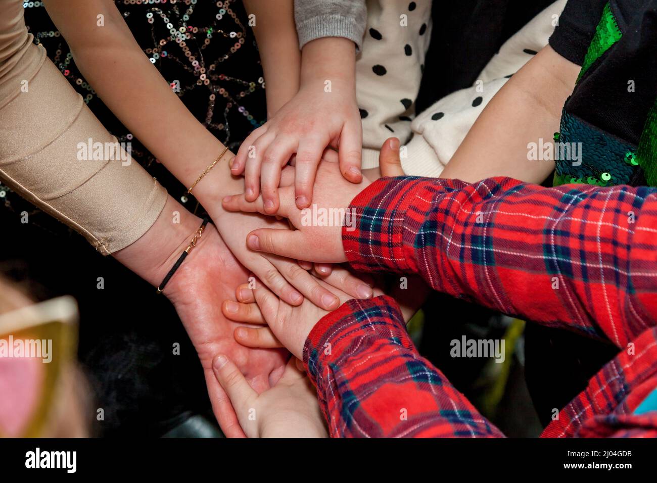 Baby hands together, team games in a children's playroom for a birthday ...