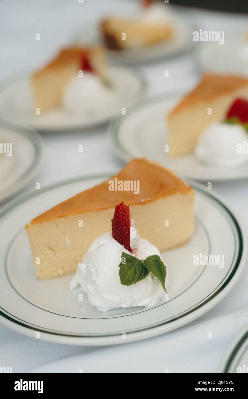 Serving of cheesecake with vanilla ice cream Stock Photo - Alamy