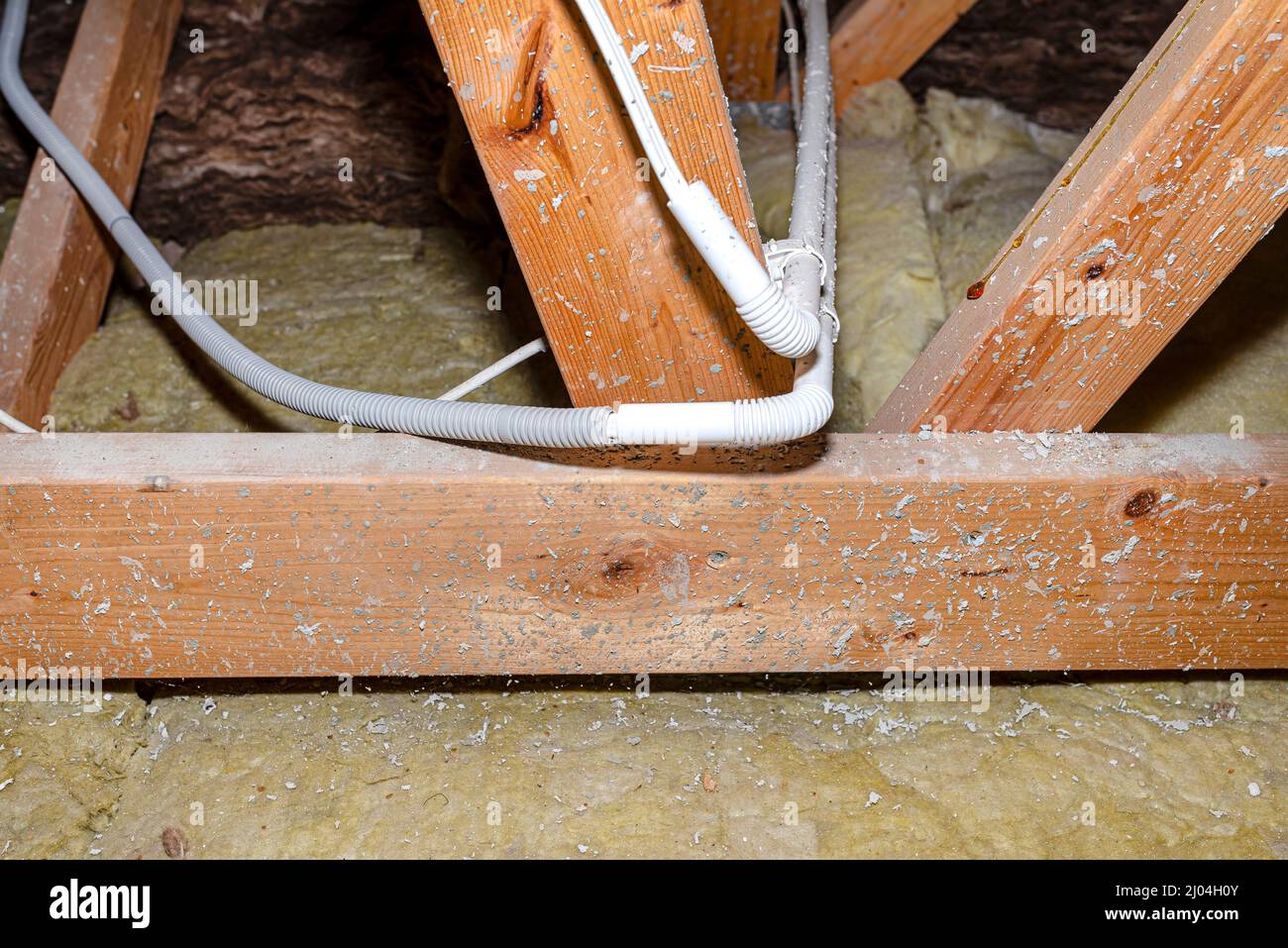Electric cable in a corrugated conduit and a PCV pipe on the roof ...