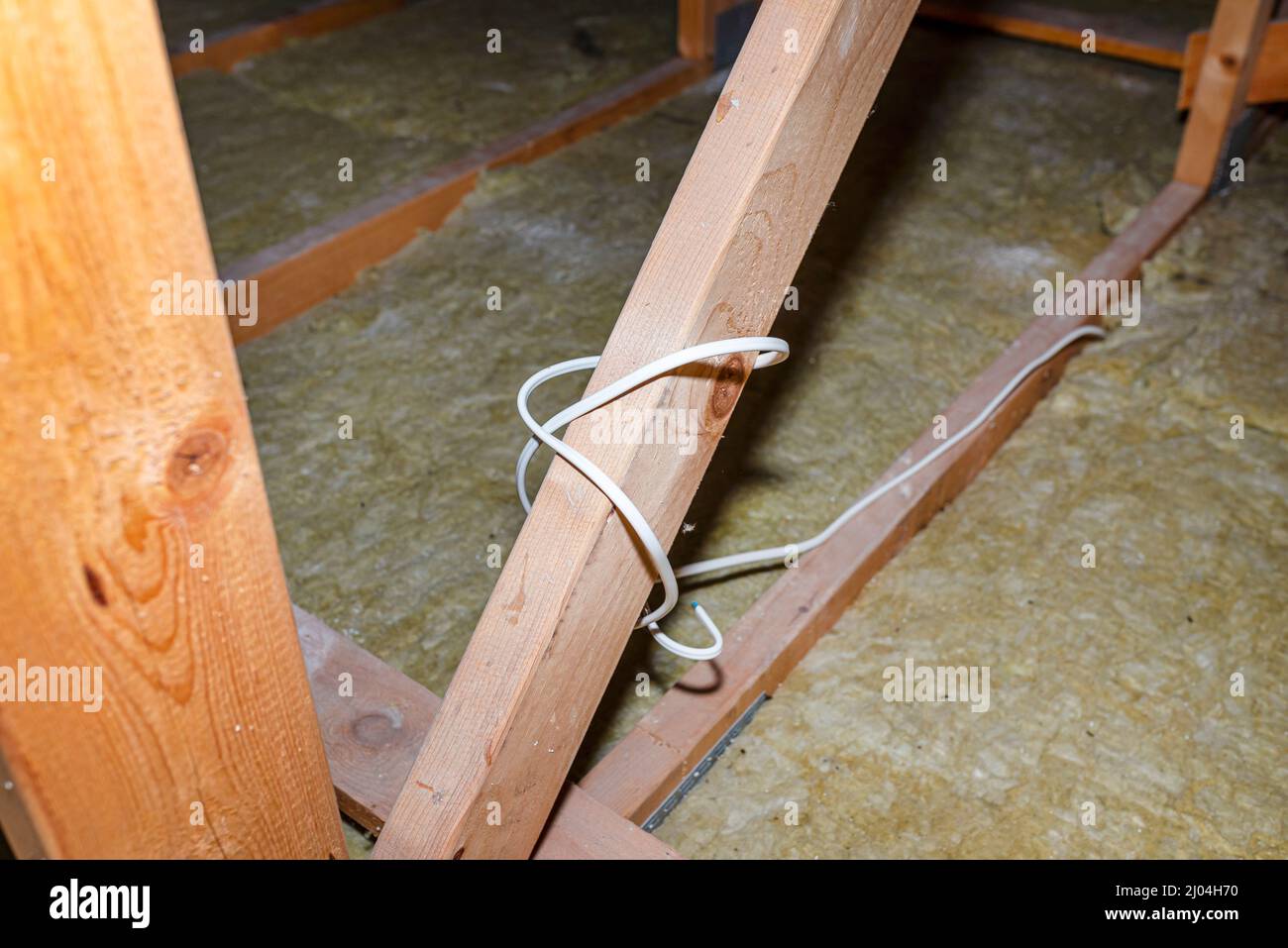 Electric cable for lighting wrapped on roof trusses in the attic of the ...