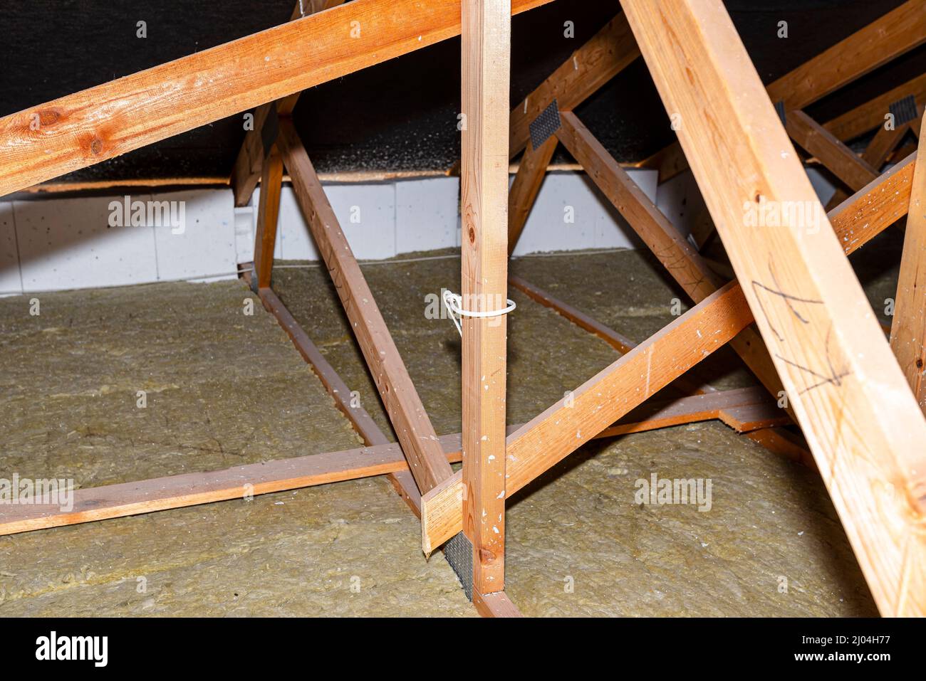 Electric cable for lighting wrapped on roof trusses in the attic of the ...