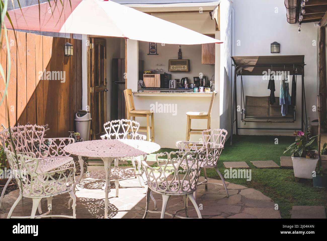 Wooden deck with stone floor in the backyard. Patio with chairs and ...