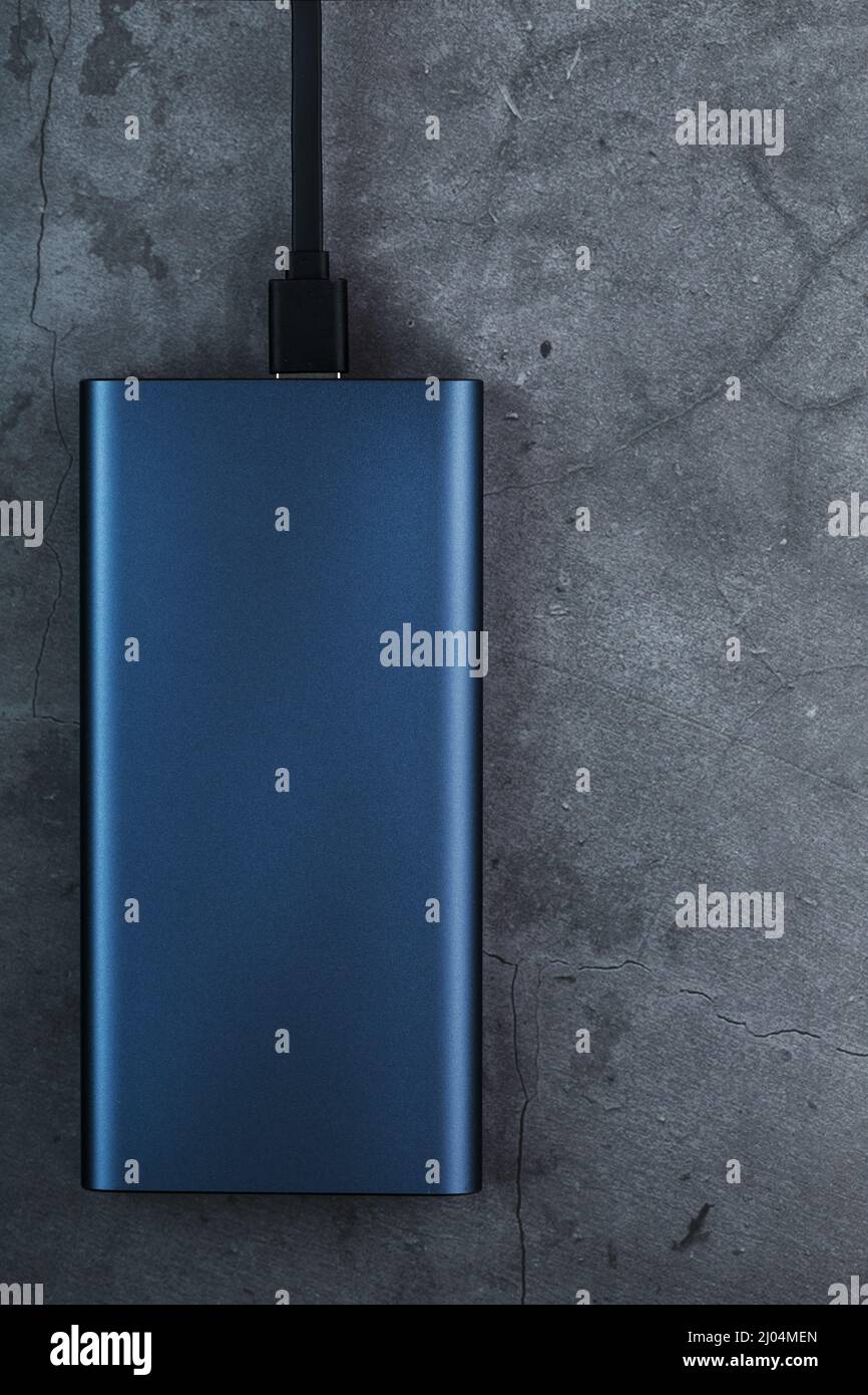 Portable External Battery Power Bank blue with USB Cord on a dark ...