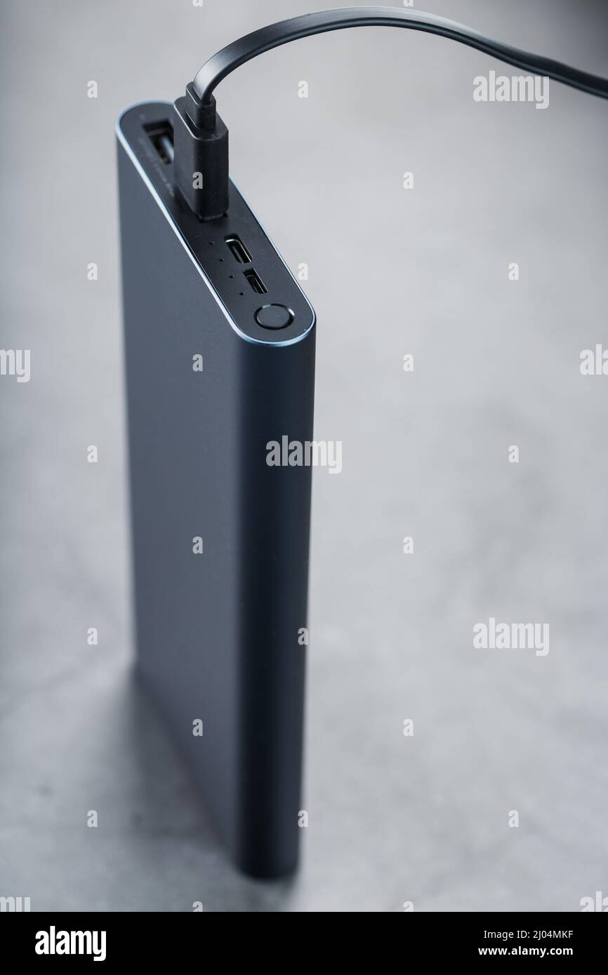 Portable External Battery Power Bank blue with USB Cord on a dark ...