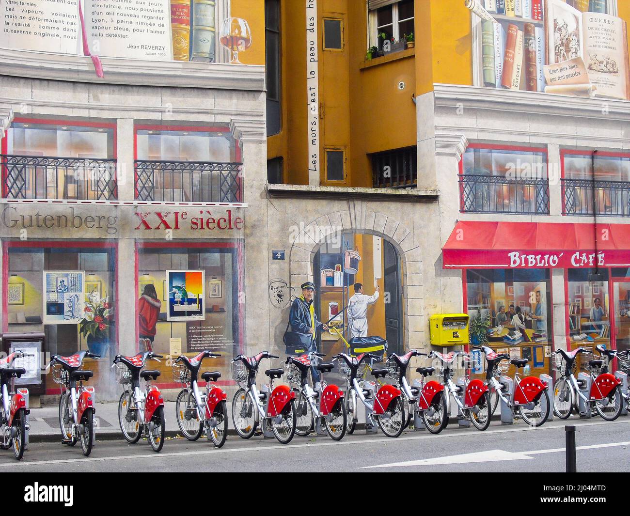 Red Biblio Cafe with a row of bikes for rent in the front in Paris ...