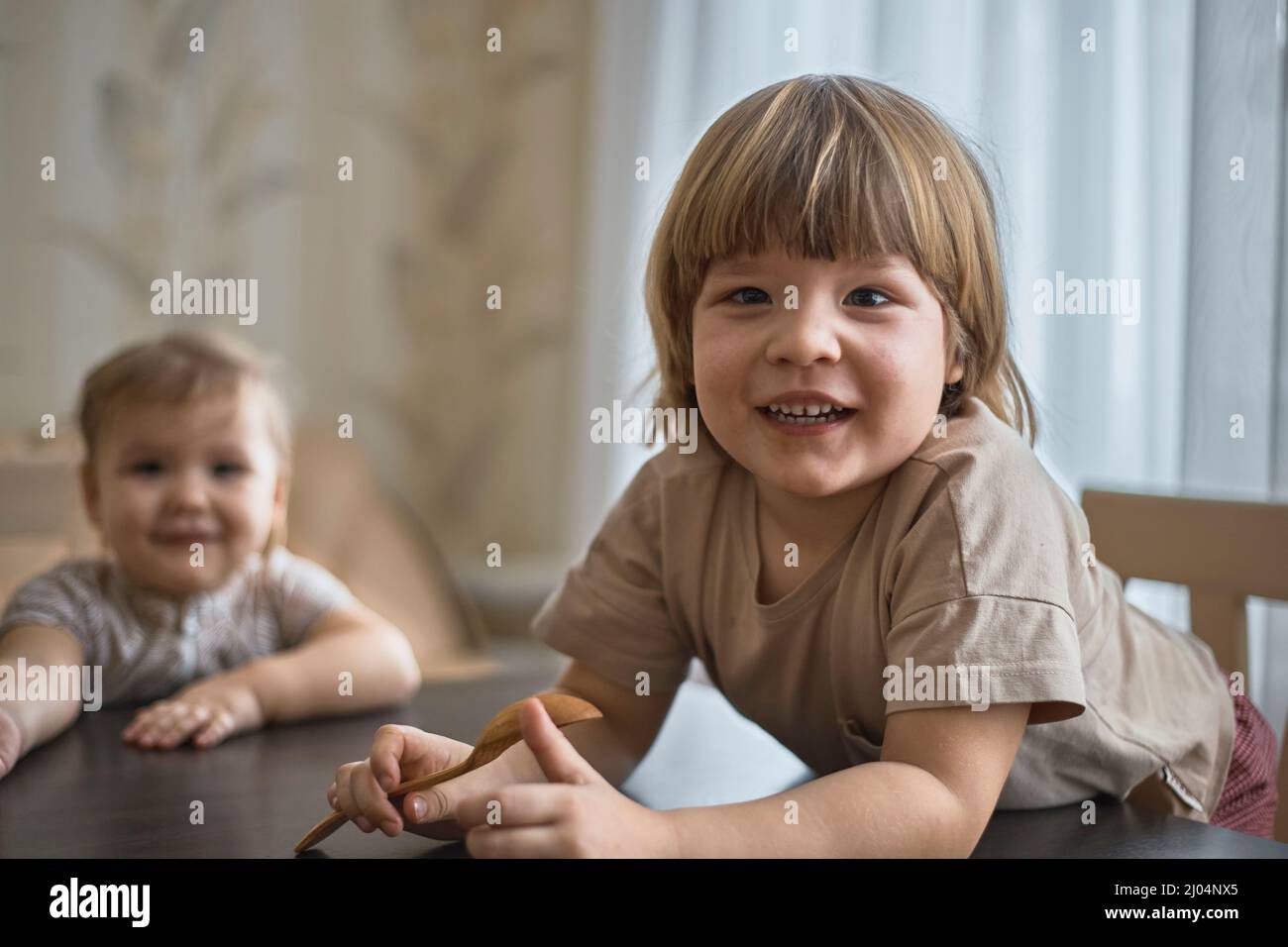 Two children look at the camera and smile Stock Photo - Alamy