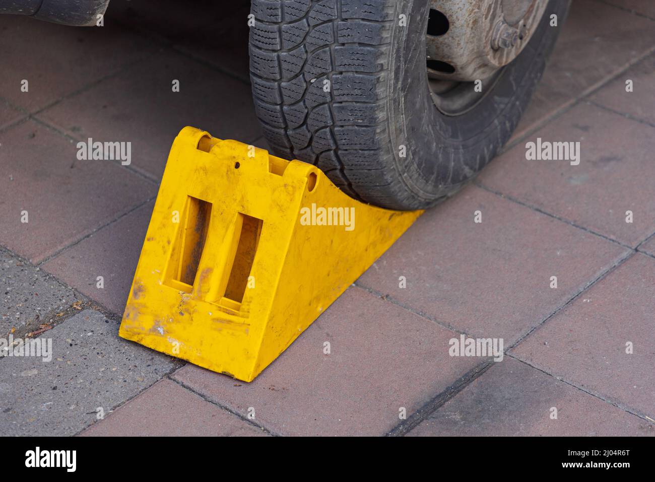 Yellow Plastic Wedge Wheel Chock Truck Parking Safety Stock Photo - Alamy