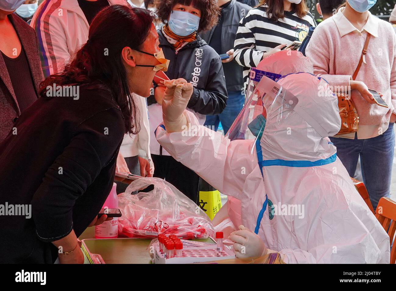A health worker wearing a Personal Protective Equipment (PPE) performs ...
