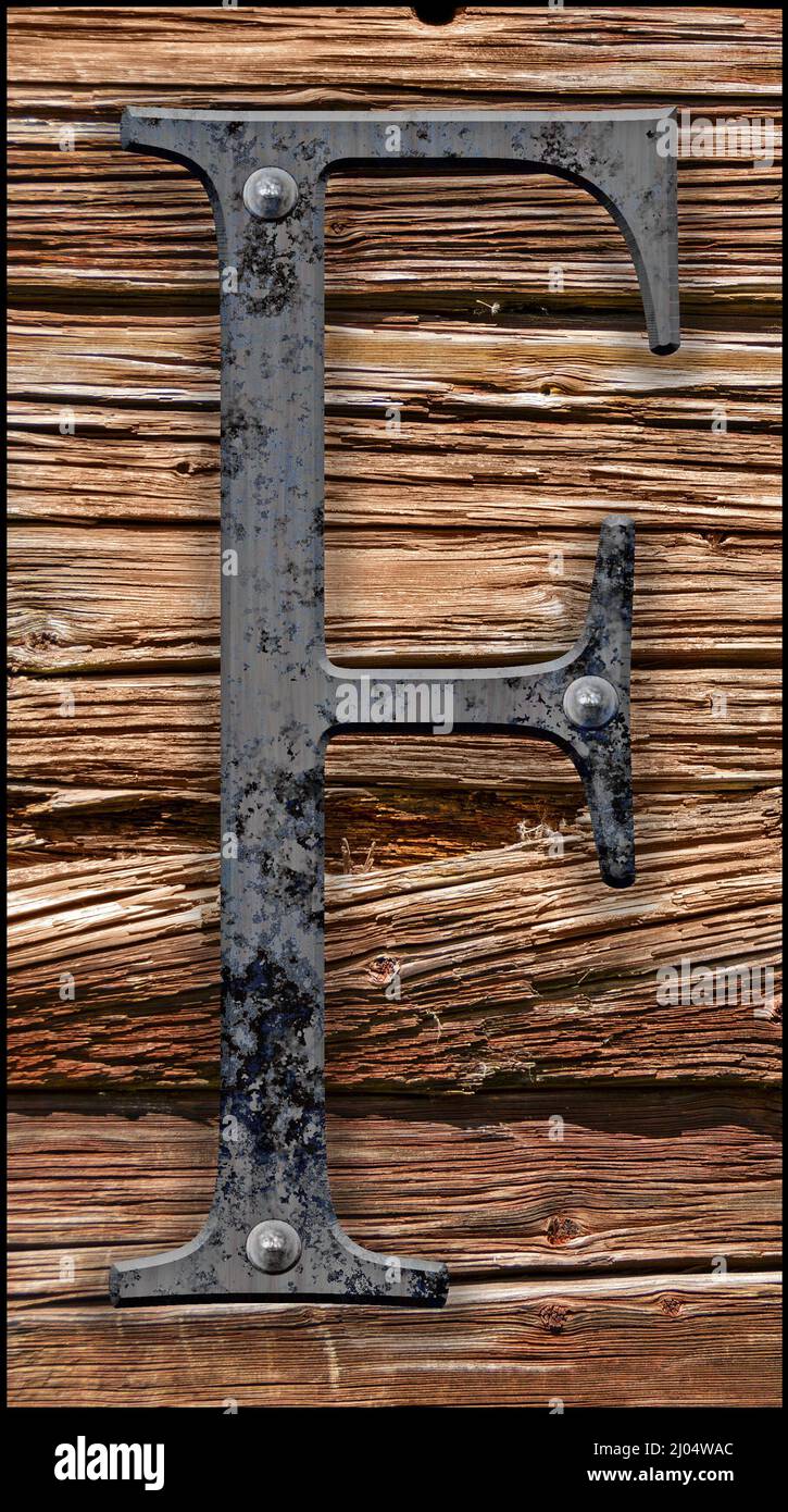 Iron letter F on old wood Stock Photo - Alamy