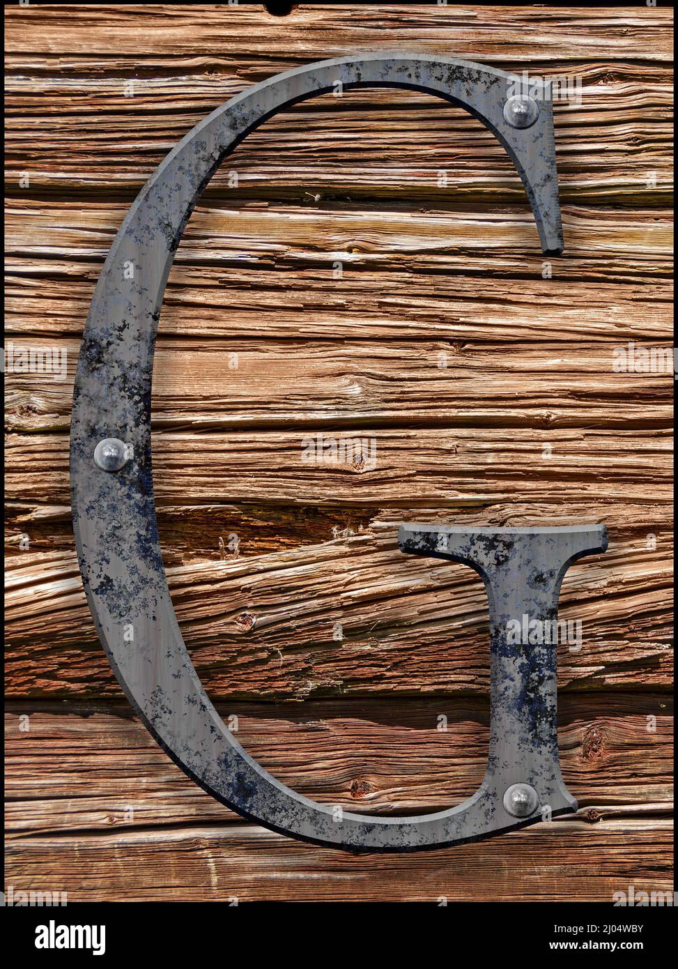 Iron letter G on old wood Stock Photo - Alamy