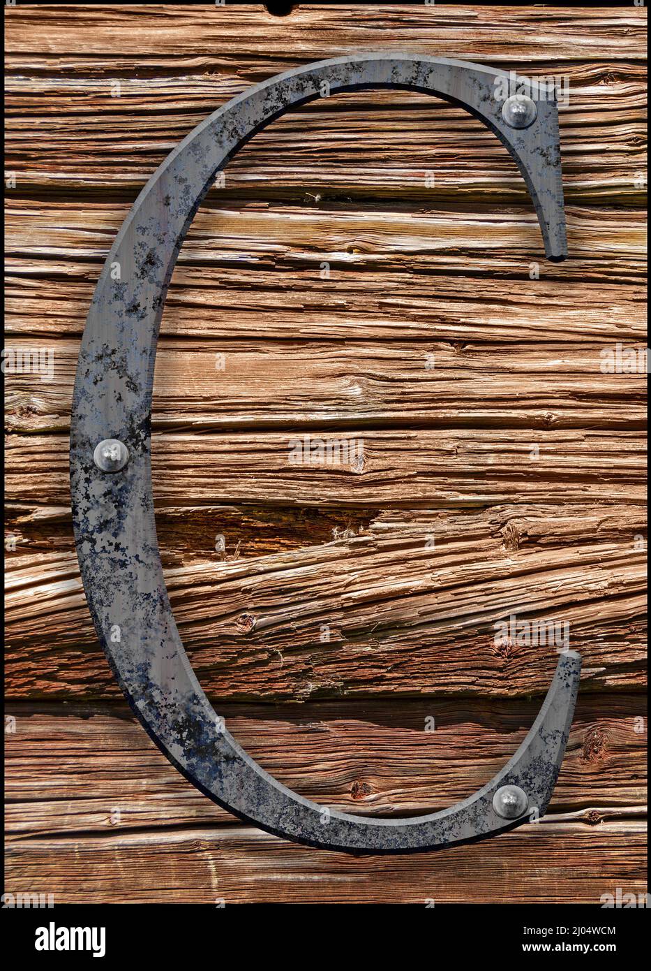 Iron letter C on old wood Stock Photo - Alamy