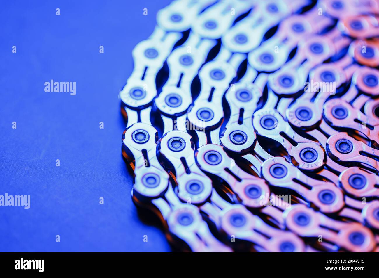 Patterns of a technological bicycle chain braided in a circle with blue ...
