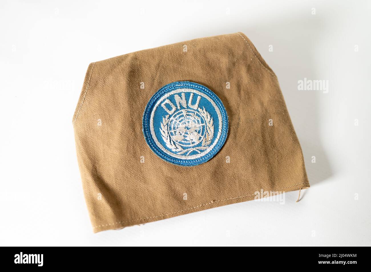 Overhead shot of United Nations Peacekeeper's armband with sewn on UN ...