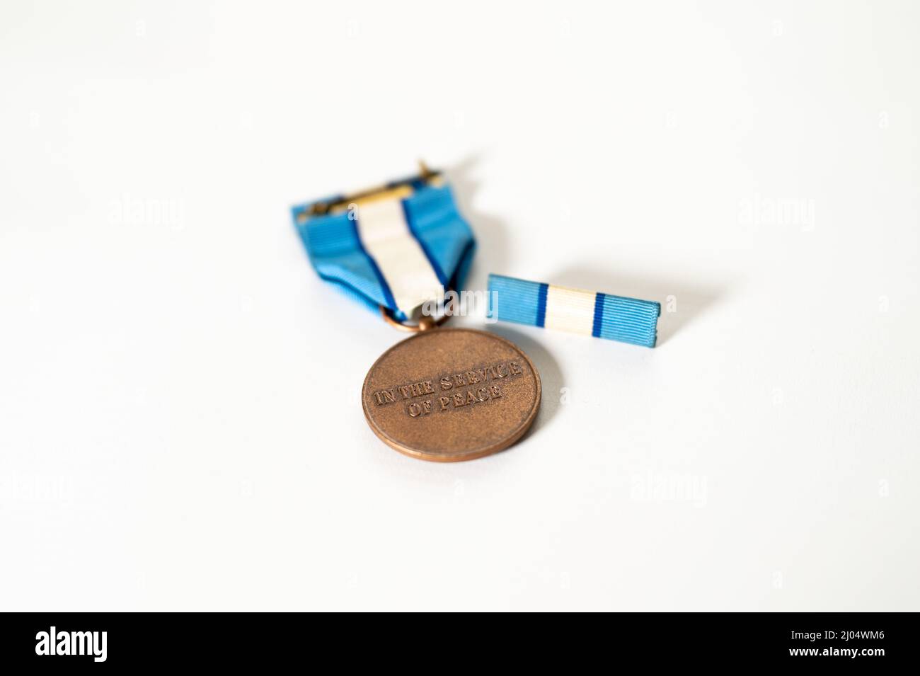 Shallow focus shot of the back of a United Nations Peacekeeper's medal ...