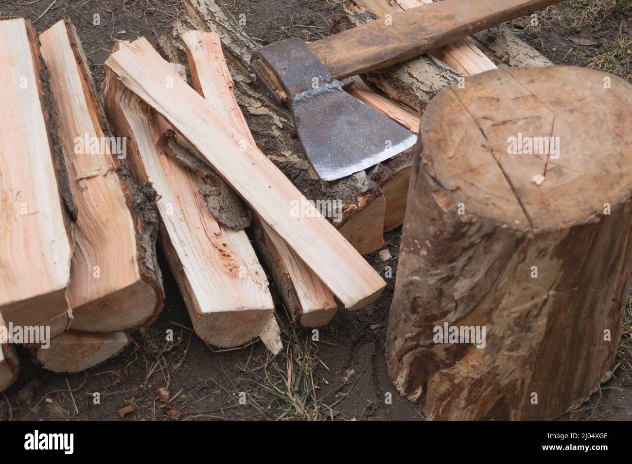 Close-up of a stack of chopped cut wood and an axe Stock Photo - Alamy