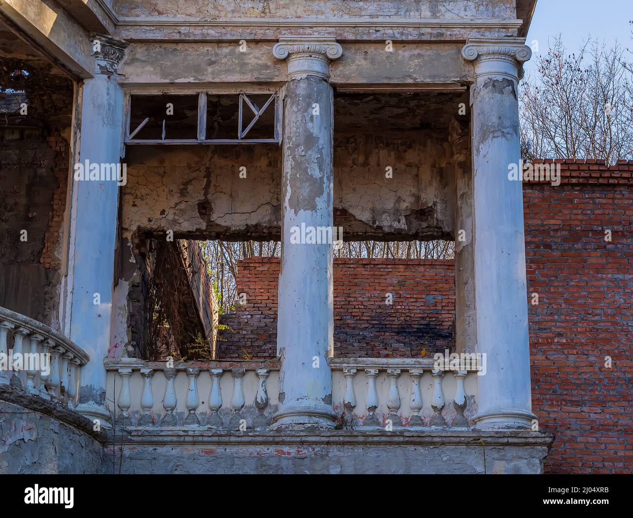 A fragment of ruined Greek-style building with shabby walls and columns ...
